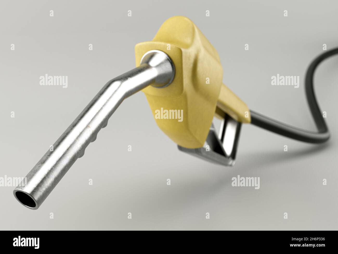 A regular yellow and metal fuel pump nozzle and pipe on an isolated ...