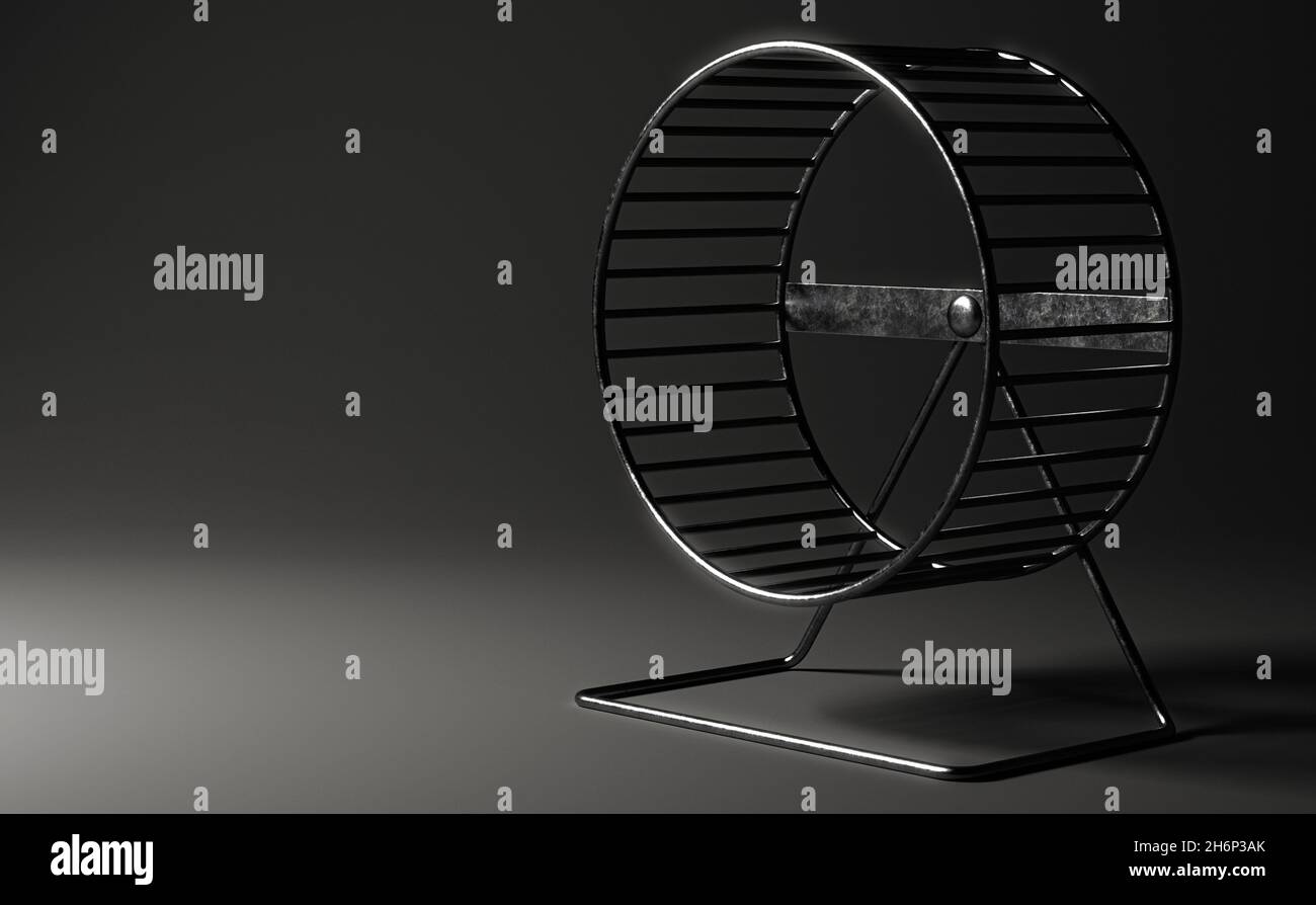 A close up of an empty metal hamster wheel on an isolated dark studio ...