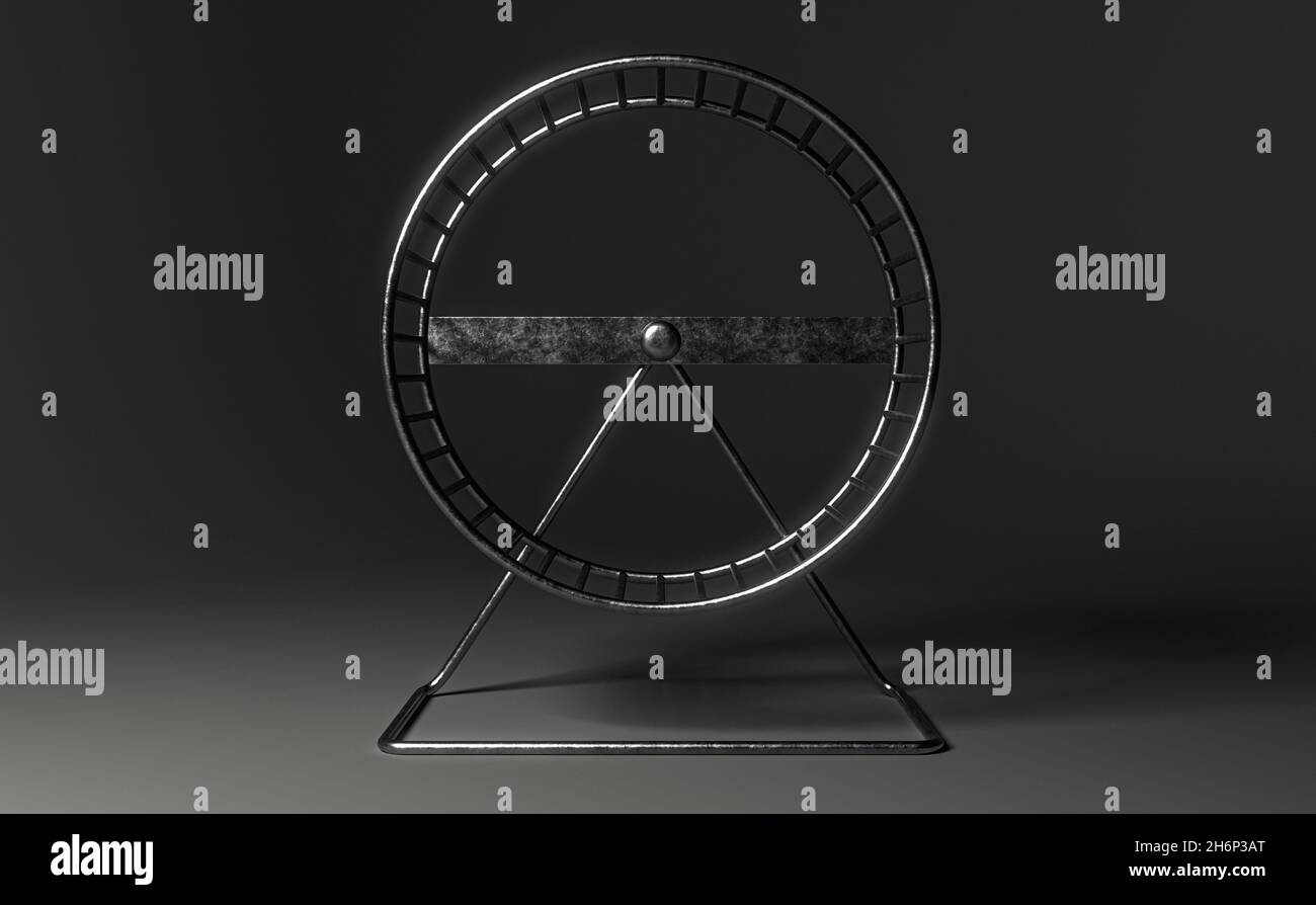 A close up of an empty metal hamster wheel on an isolated dark studio ...
