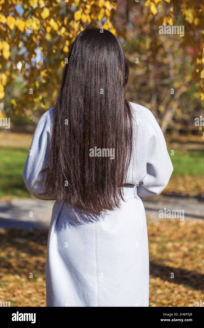 Brunette hair model. Back view young woman, autumn park outdoor Stock ...