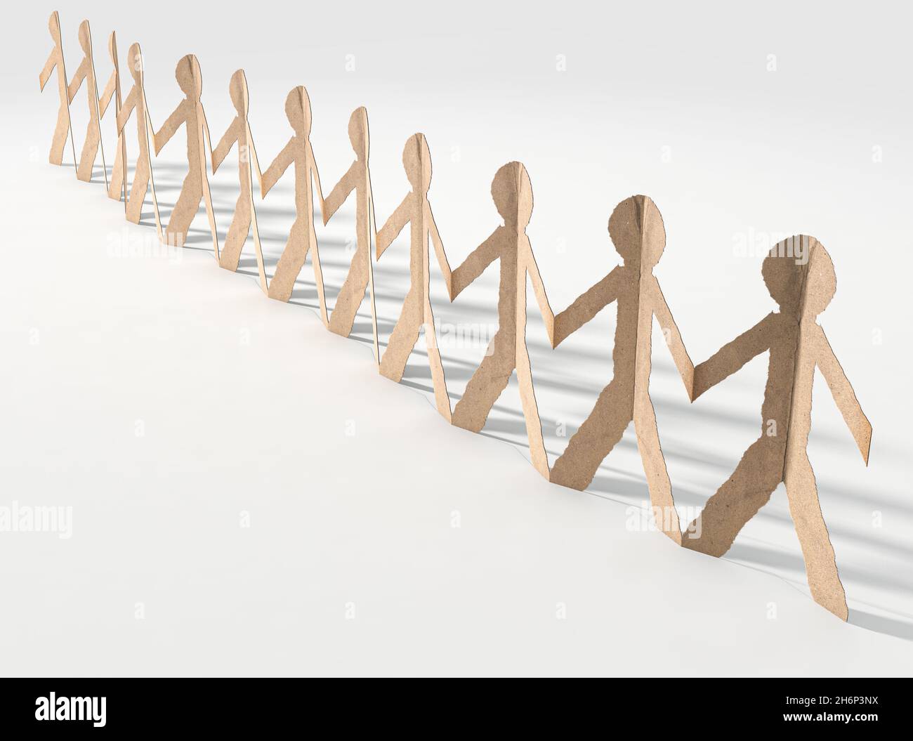 A row of brown cardboard cutout men on an isolated white studio ...