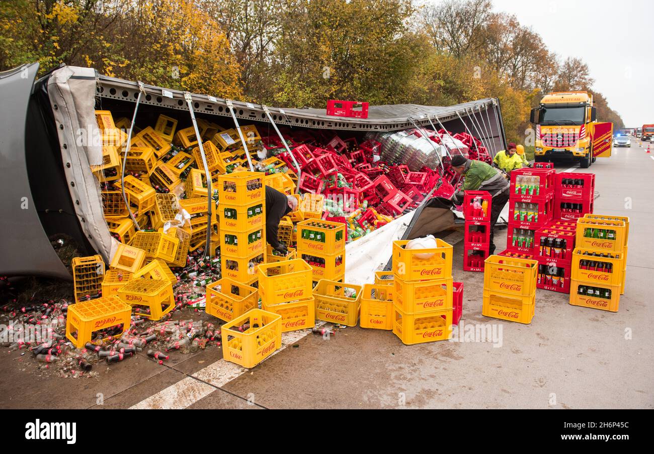Talkau, Germany. 17th Nov, 2021. Men stacking crates of drinks from the ...