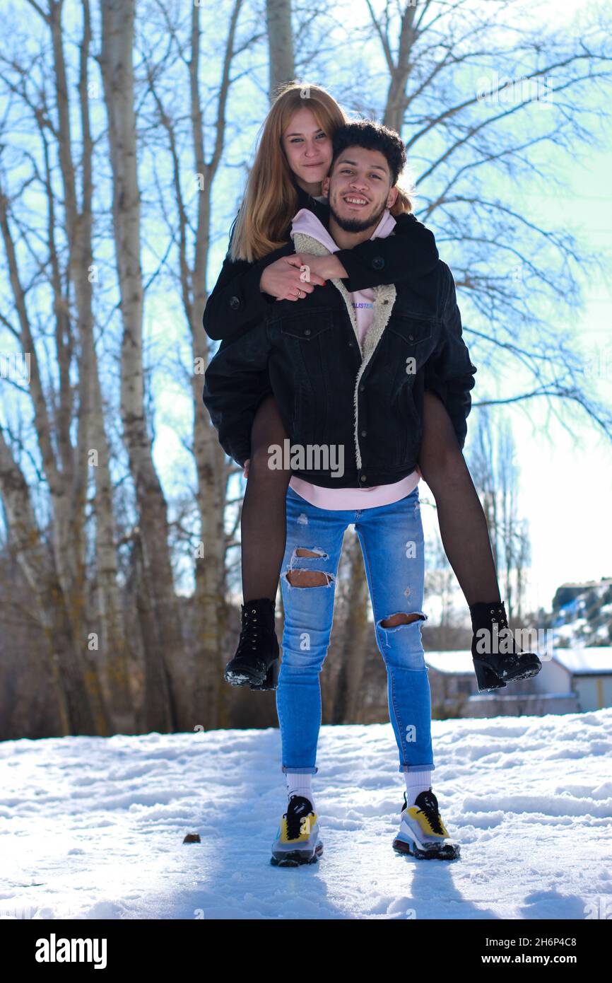 Vertical image of a blonde Caucasian girl riding on the shoulders Stock ...