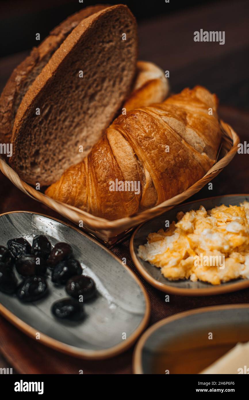 Traditional Turkish breakfast with fried egg, black olives, croissant ...