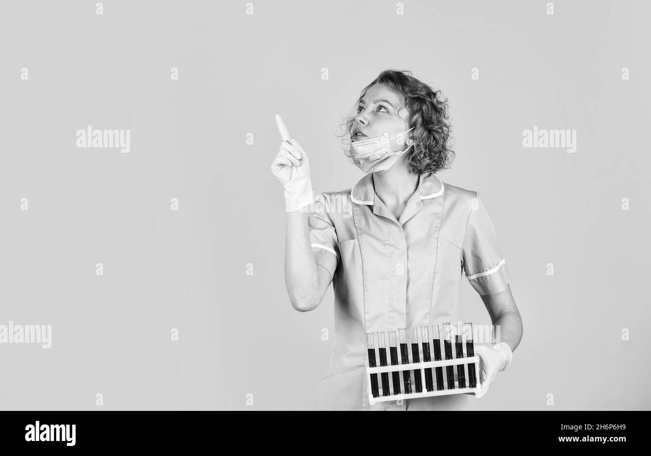 this solution is right. Investigator checking test tubes. woman wears ...