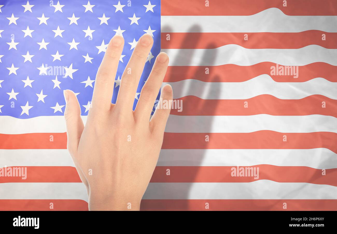 A woman's hand on the background of the national flag of America. A ...