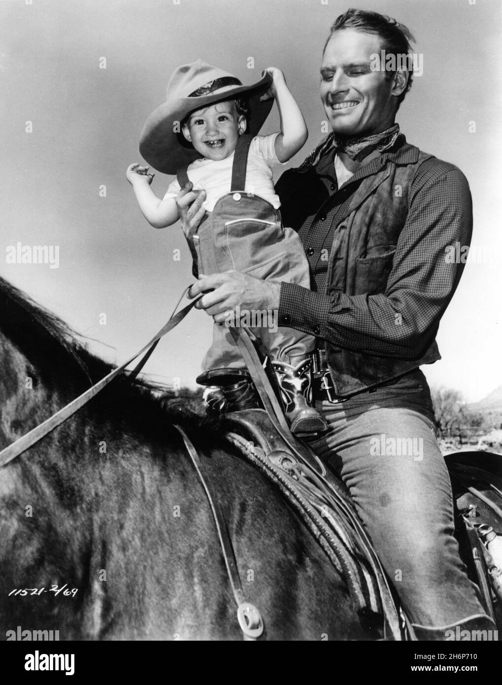 CHARLTON HESTON with his one year old son FRASER HESTON on set location ...