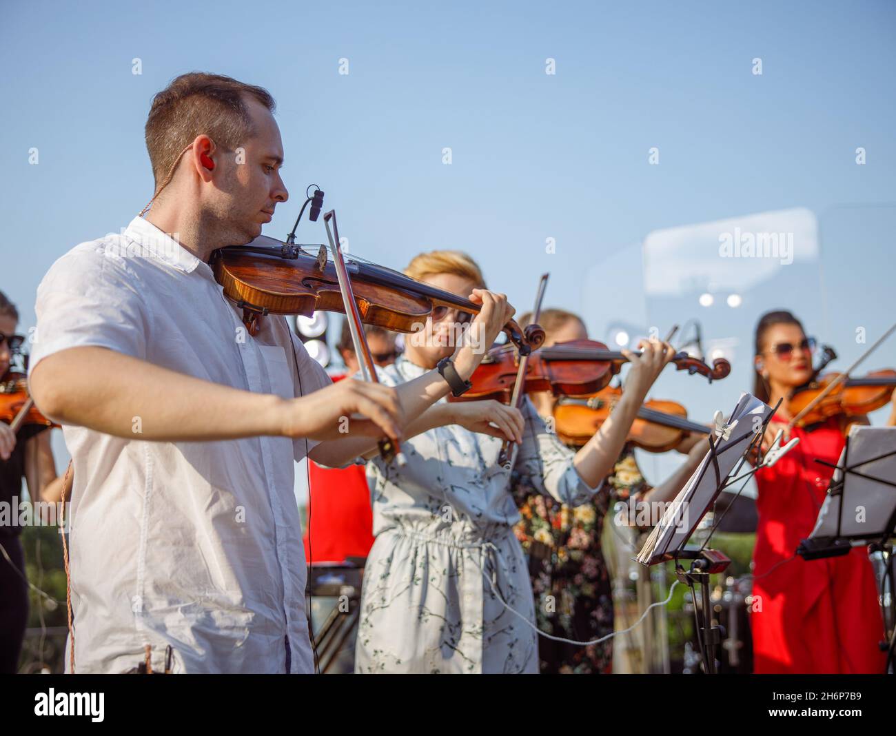 Violin players having orchestral rehearsal on the street Stock Photo ...