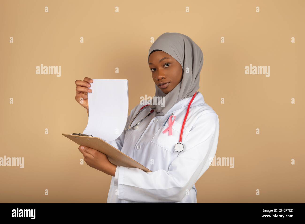 Muslim female doctor holding document Stock Photo - Alamy