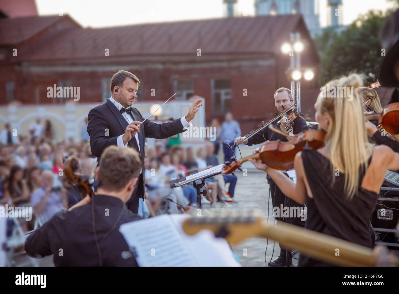 Conductor directing orchestra performance on the street Stock Photo - Alamy