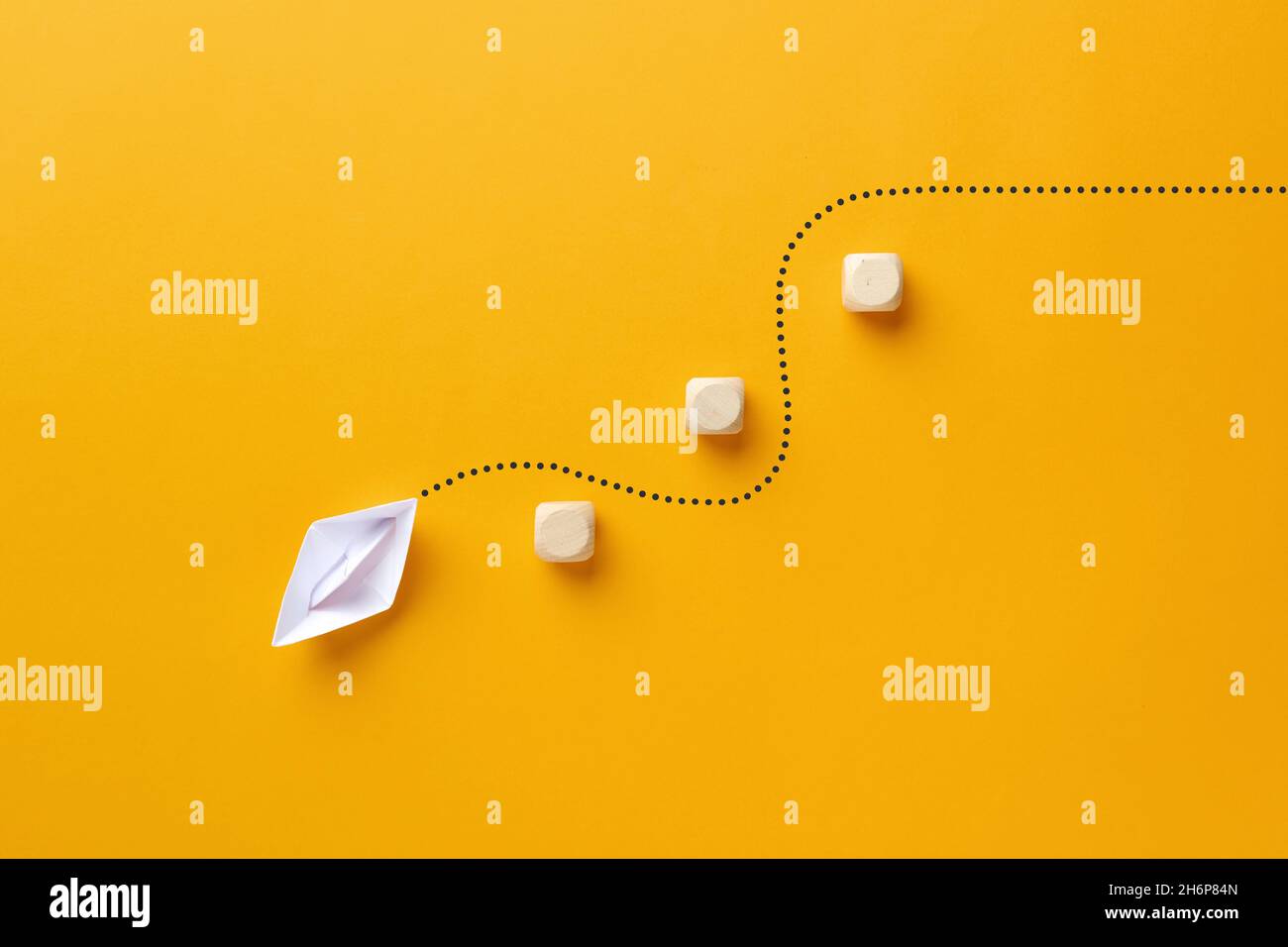 Origami paper boat passes through the wooden cube barriers. To overcome ...