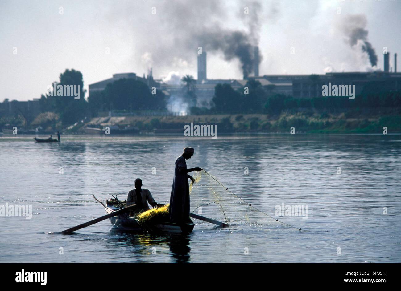 EGYPT. NILE VALLEY. FISHERMEN RAISING THEIR NETS ON THE NILE NEAR THE ...