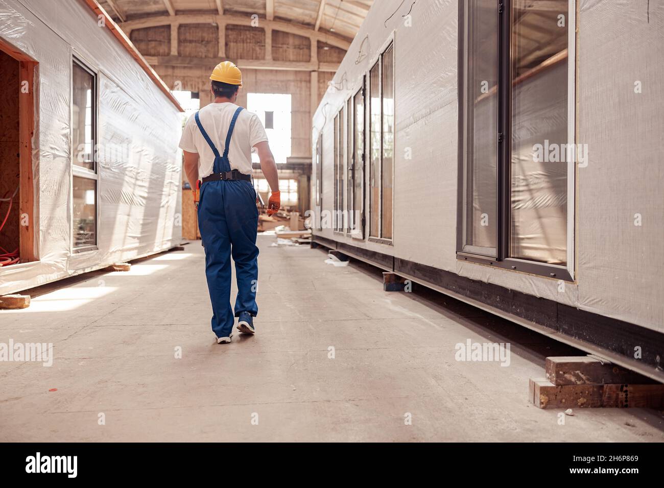 Male worker walking down the building under construction Stock Photo ...