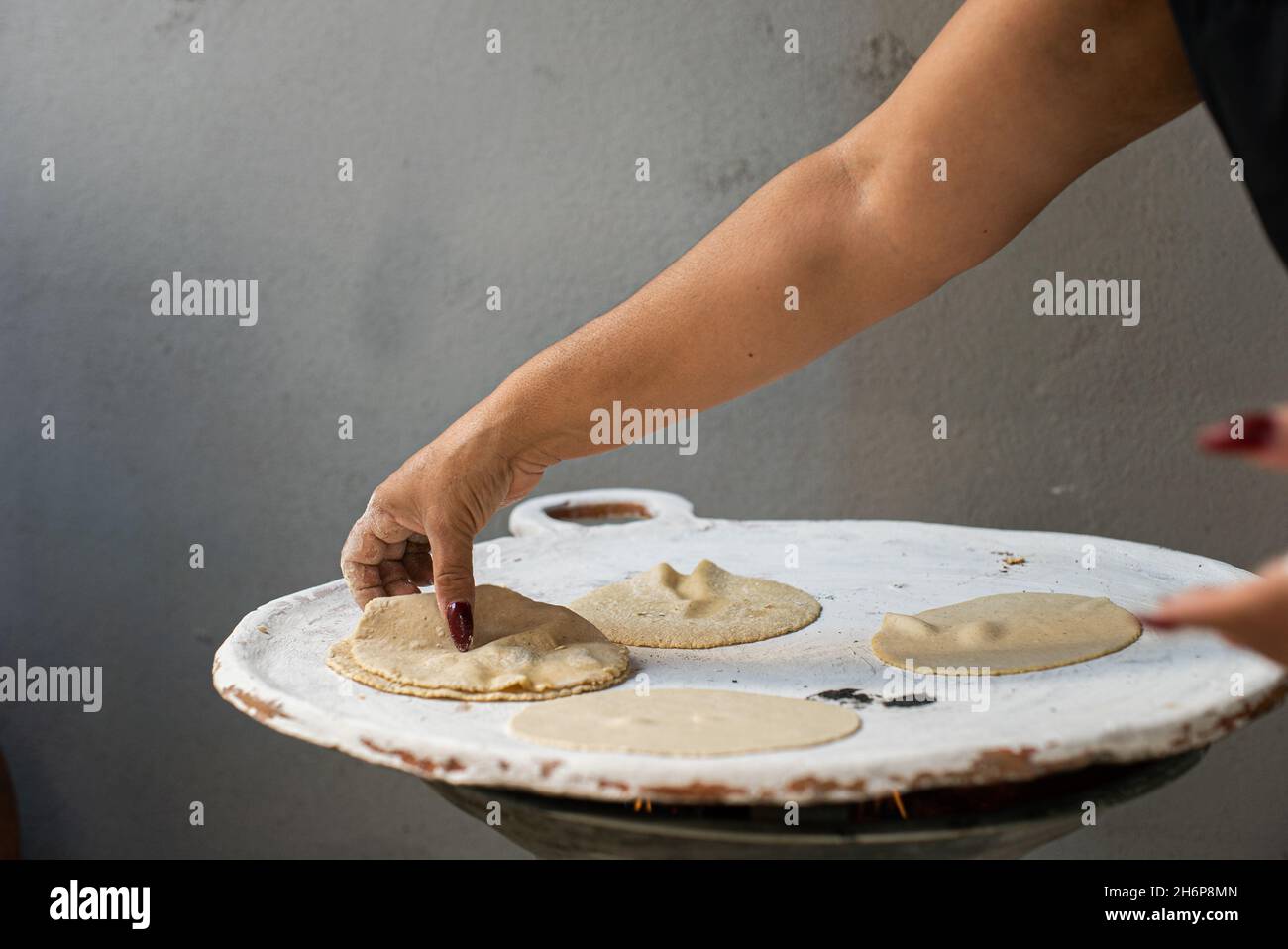 Closeup of the woman's hand making dough tortillas Stock Photo - Alamy