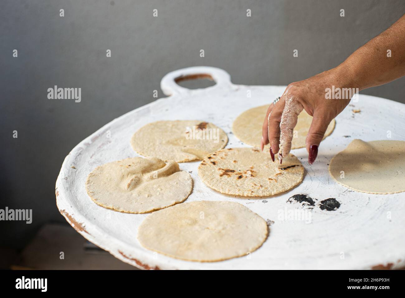 Closeup of the woman's hand making dough tortillas Stock Photo - Alamy