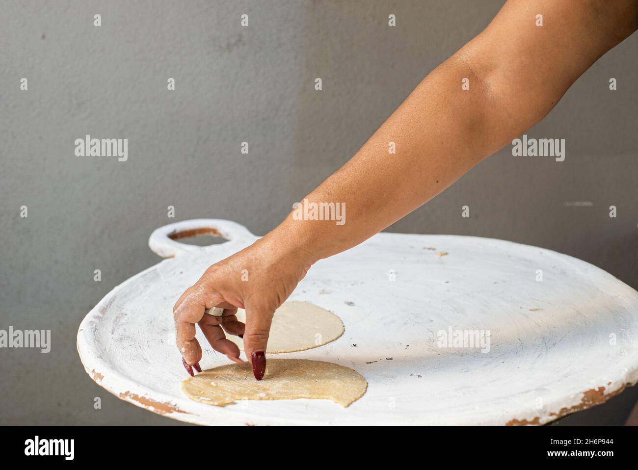 Closeup of the woman's hand making dough tortillas Stock Photo - Alamy