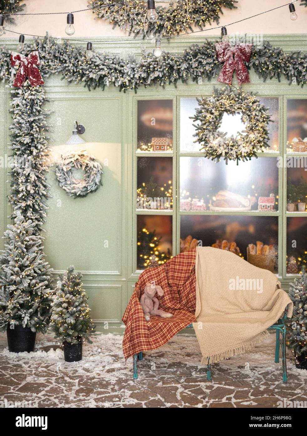 Bench near Christmas cafe bakery at snowy street Stock Photo - Alamy