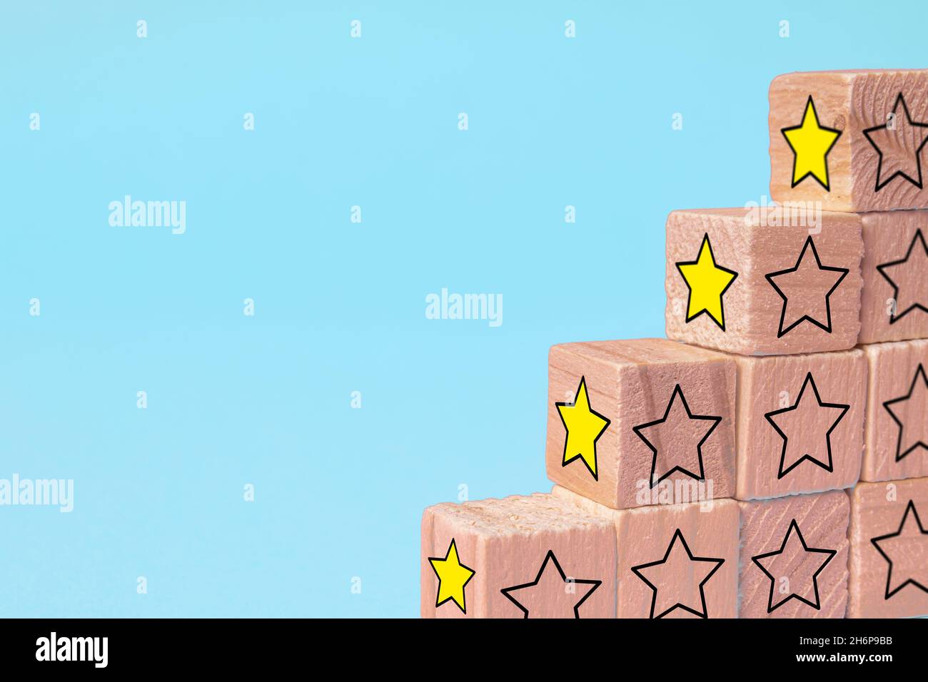 Wooden cubes with star icons on a blue background - the concept of ...