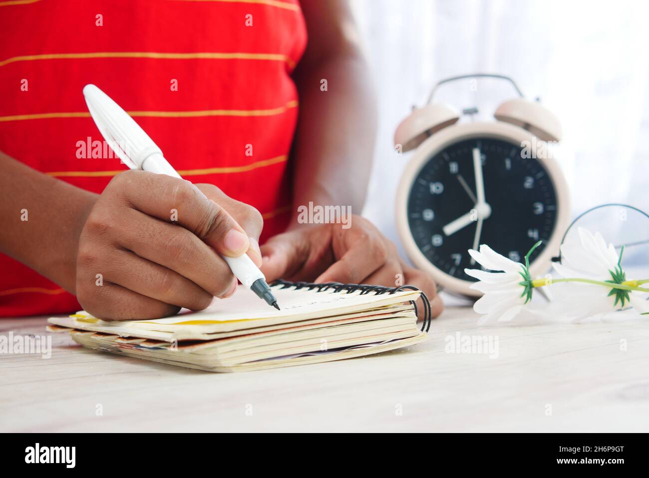 child boy hand writing on notepad Stock Photo - Alamy