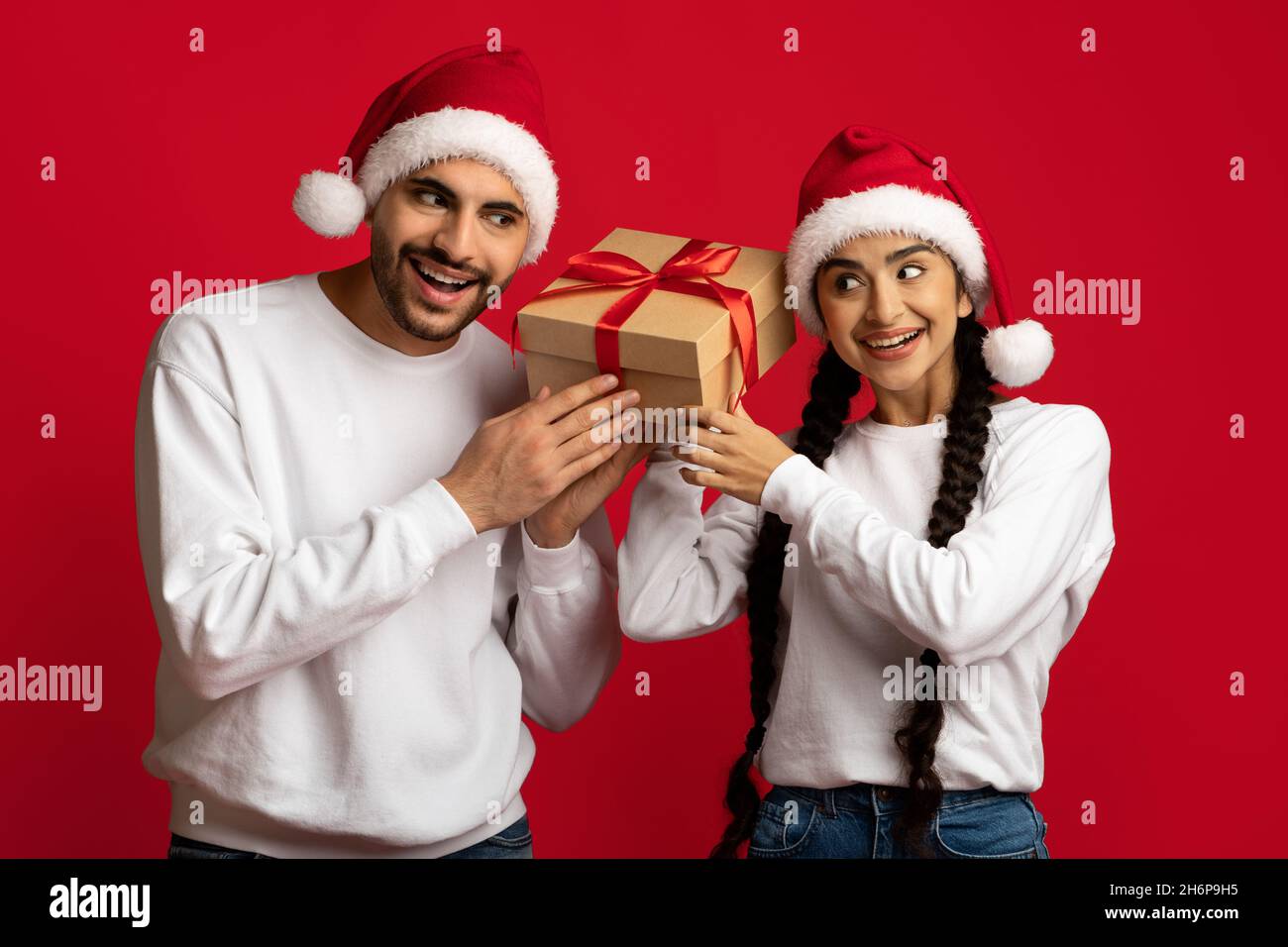 Woman shaking gift box hi-res stock photography and images - Alamy
