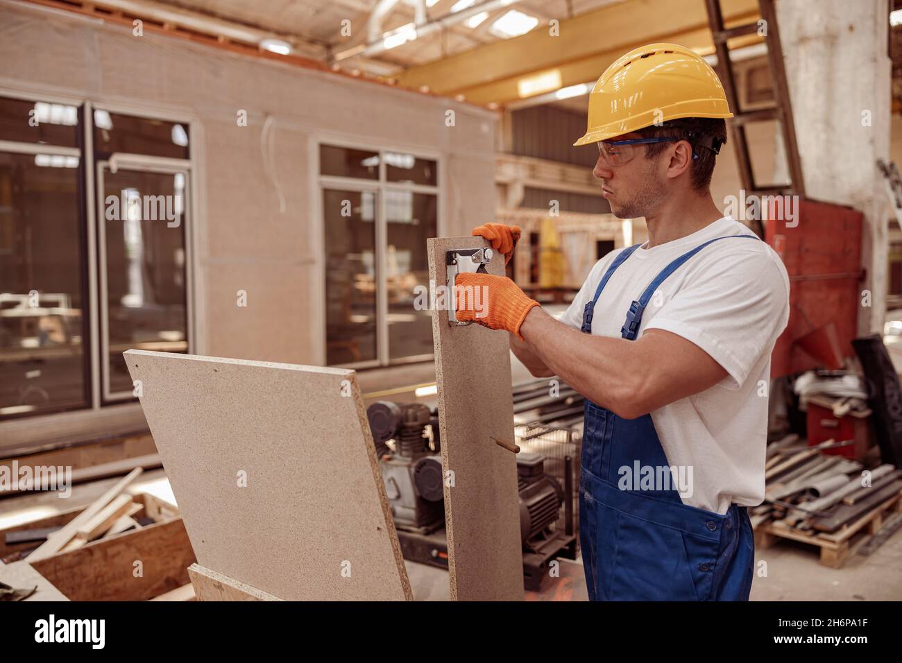 Handsome young man construction worker wearing safety helmet and work ...