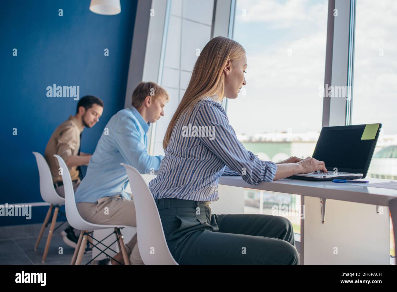 Employees sit at a desk and work Stock Photo - Alamy