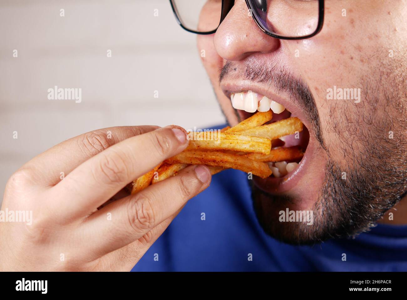 Man eating french fries hi-res stock photography and images - Alamy