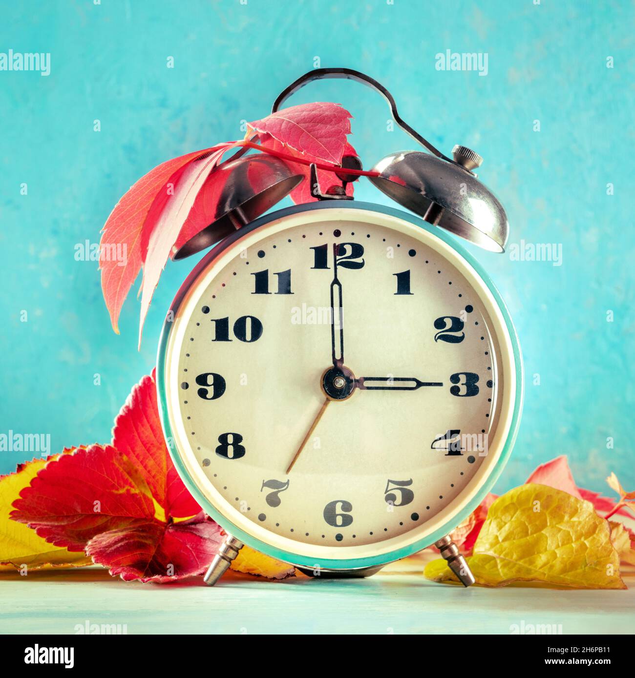 Daylight Saving Time concept, fall back in autumn, square image. A ...