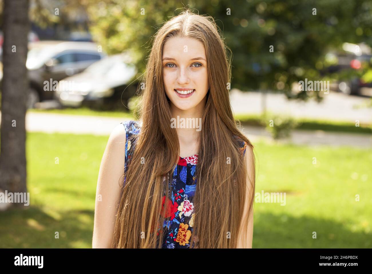 Close up portrait of a young beautiful brunette girl in summer park ...