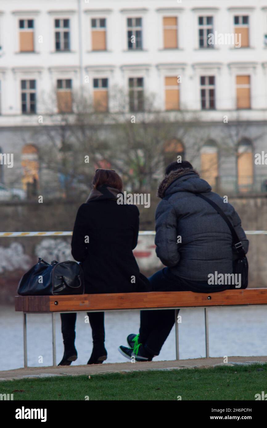 A man and a woman from behind sitting on a bench Stock Photo - Alamy