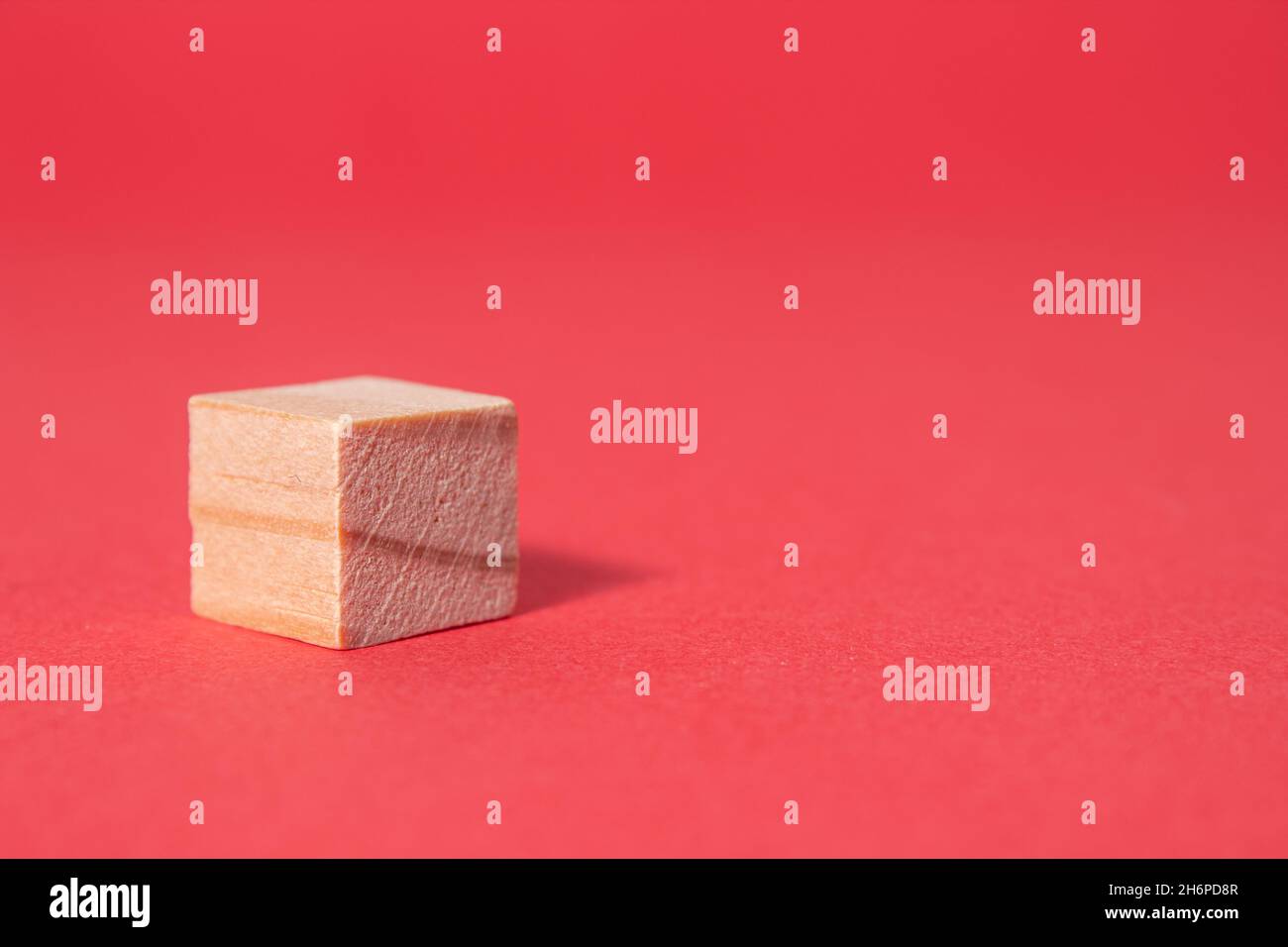 Wooden cube without an icon on a red background Stock Photo - Alamy
