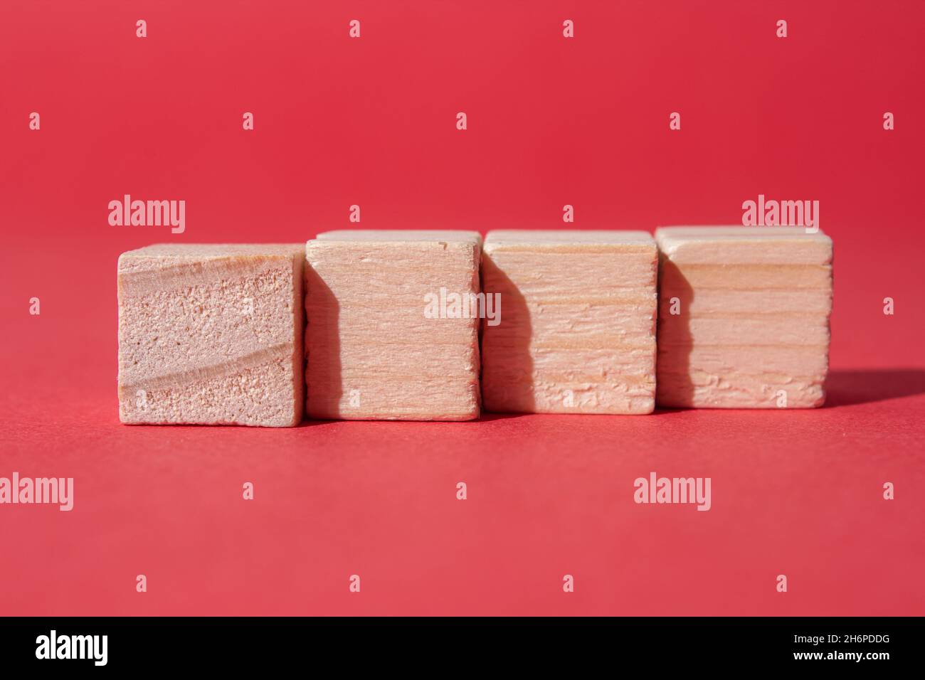 Wooden cubes without icons on a red background Stock Photo - Alamy