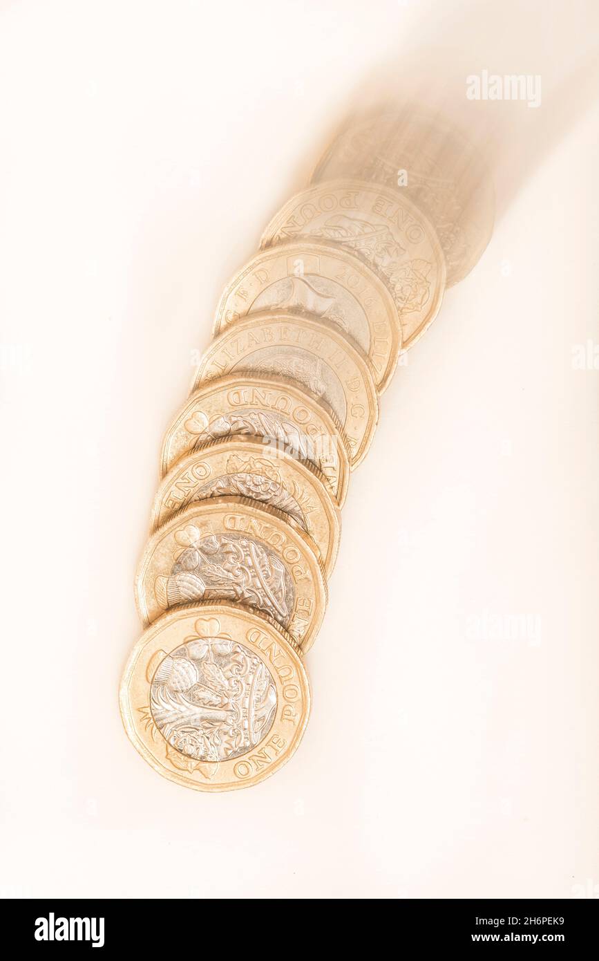 Money: Close up of One pound coins apparently falling / dropping or ...
