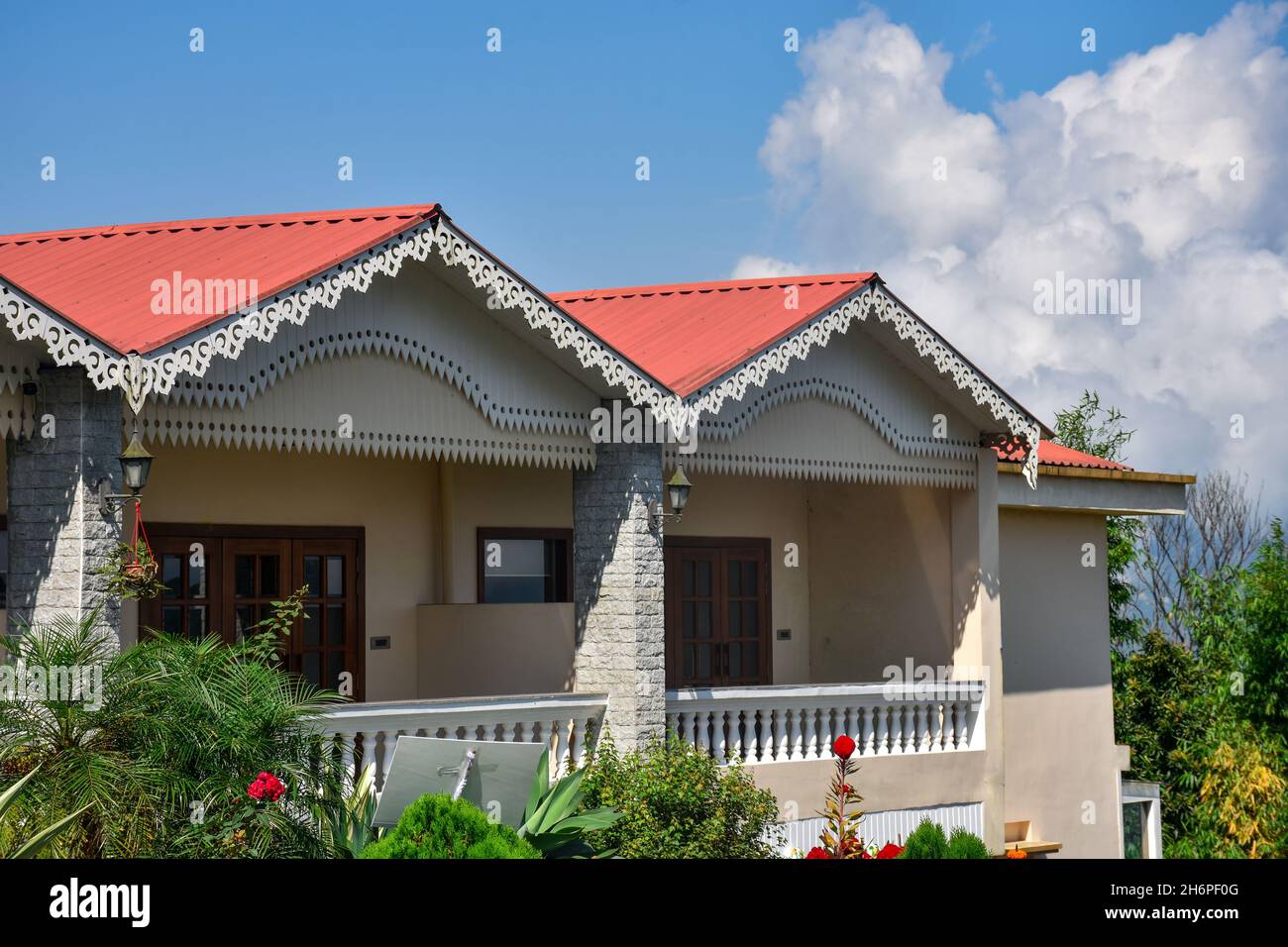 Beautiful red alpine metallic roof and blue cloudy sky Stock Photo - Alamy