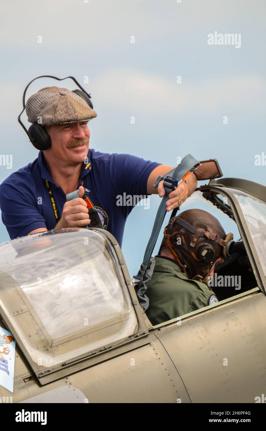 Howard Cook helping pilot Flt Lt Charlie Brown to strap in to a ...