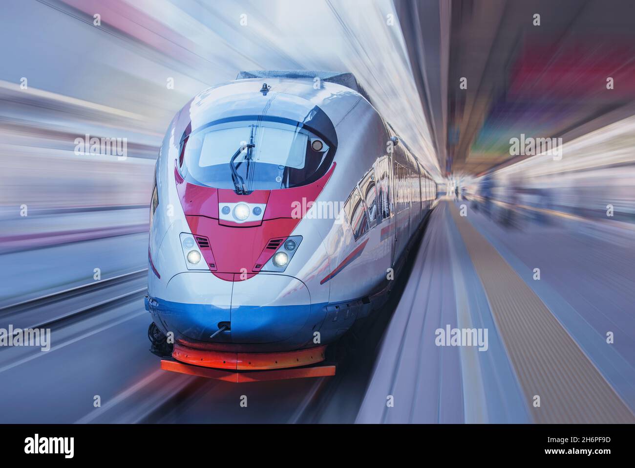 Modern high-speed train moves fast along the platform Stock Photo - Alamy