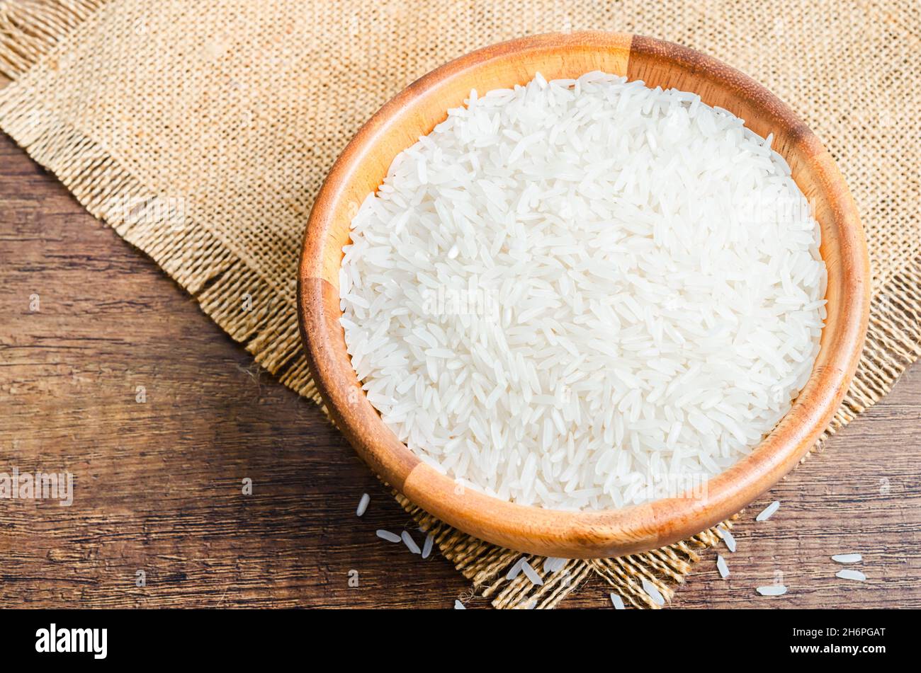 Organic Thai Jasmine rice grain in wooden bowl preparing for cooked ...