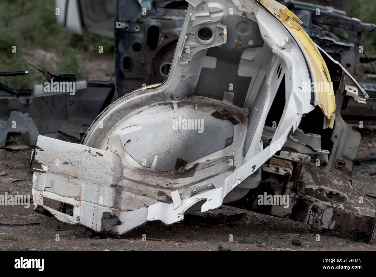 Metal demolished white car body parts abandoned outdoors close-up. Car ...