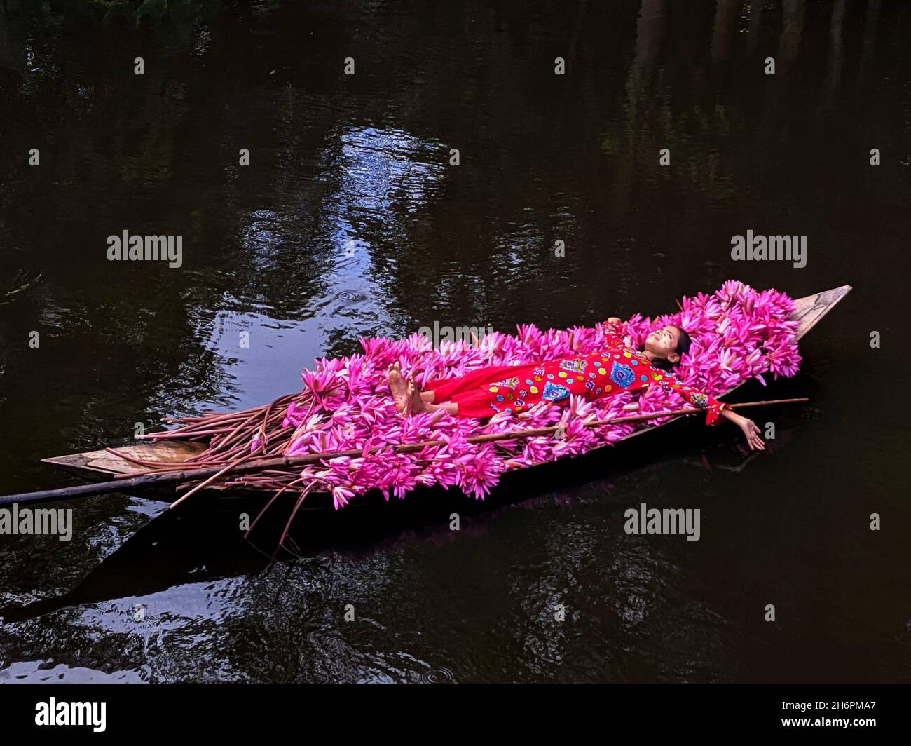 Barisal. 17th Nov, 2021. A girl poses for a photo while lying on a boat ...