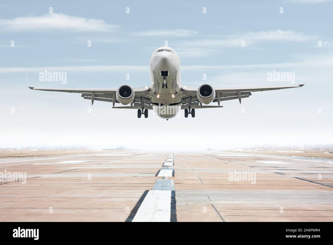 White passenger jet plane take off from airport runway Stock Photo - Alamy