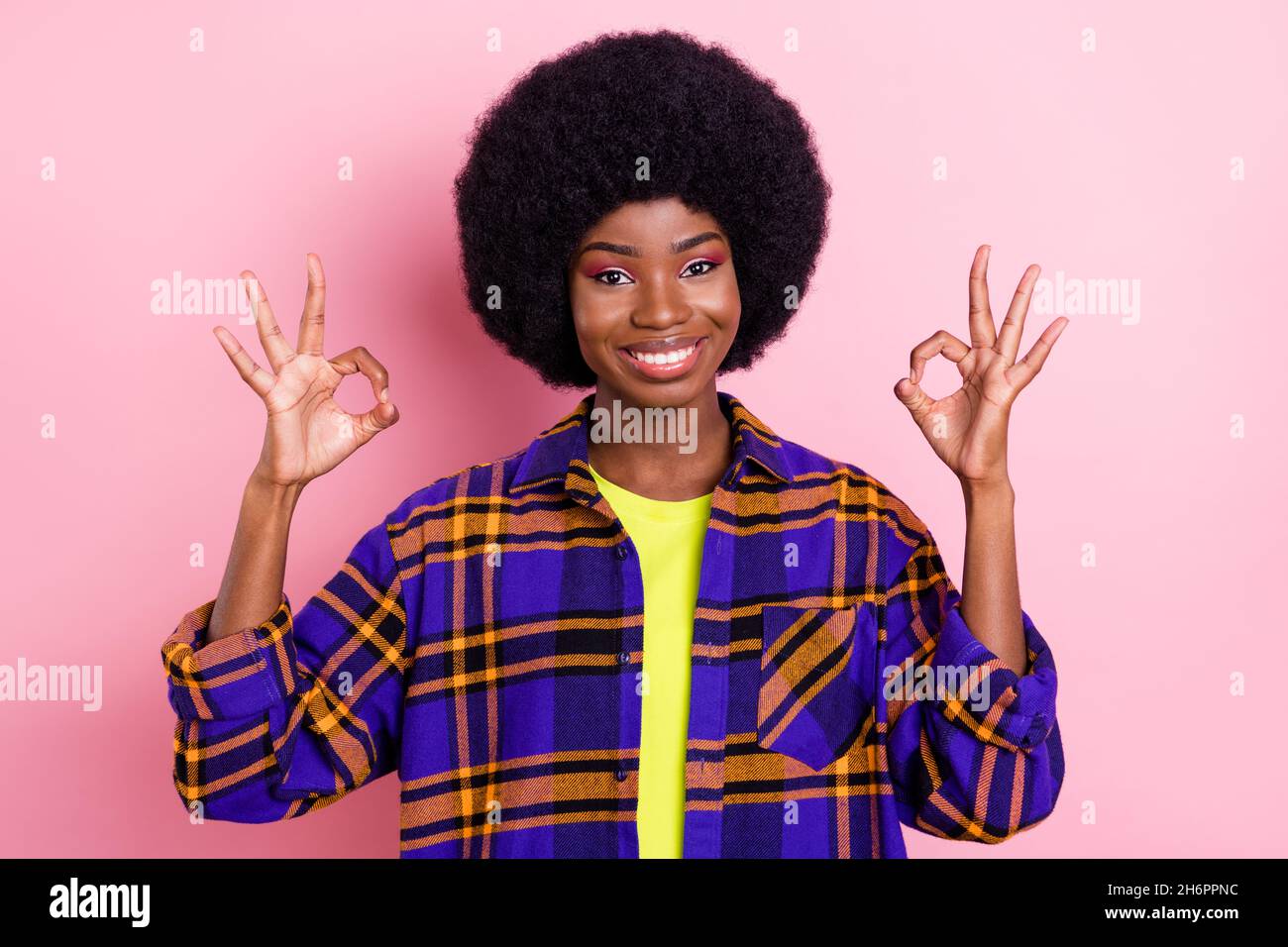 Portrait of attractive cheerful girl showing double ok-sign ad solution ...