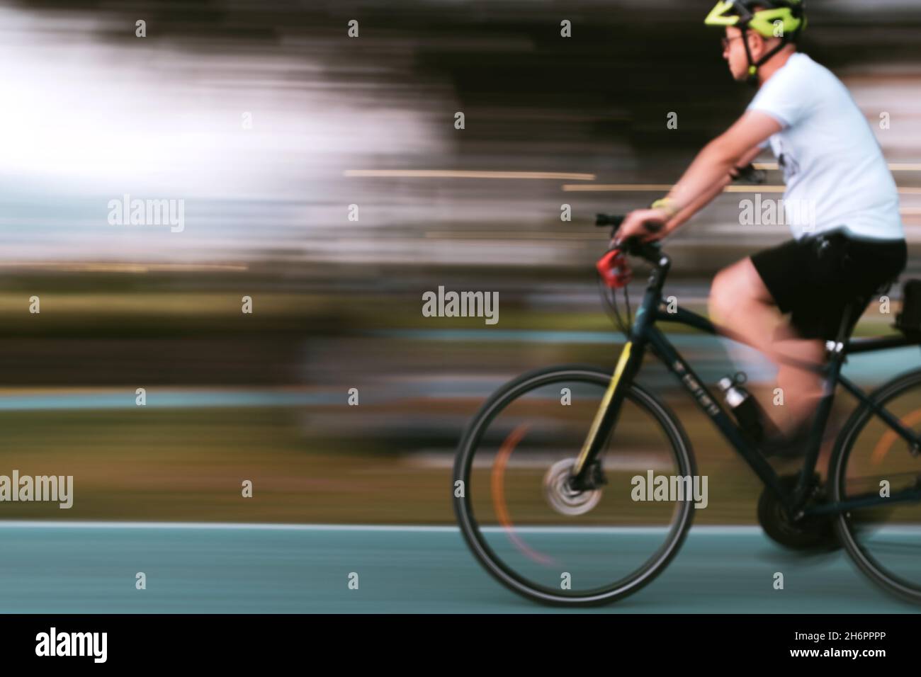 A young man is riding a bicycle. Motion blur image Stock Photo - Alamy