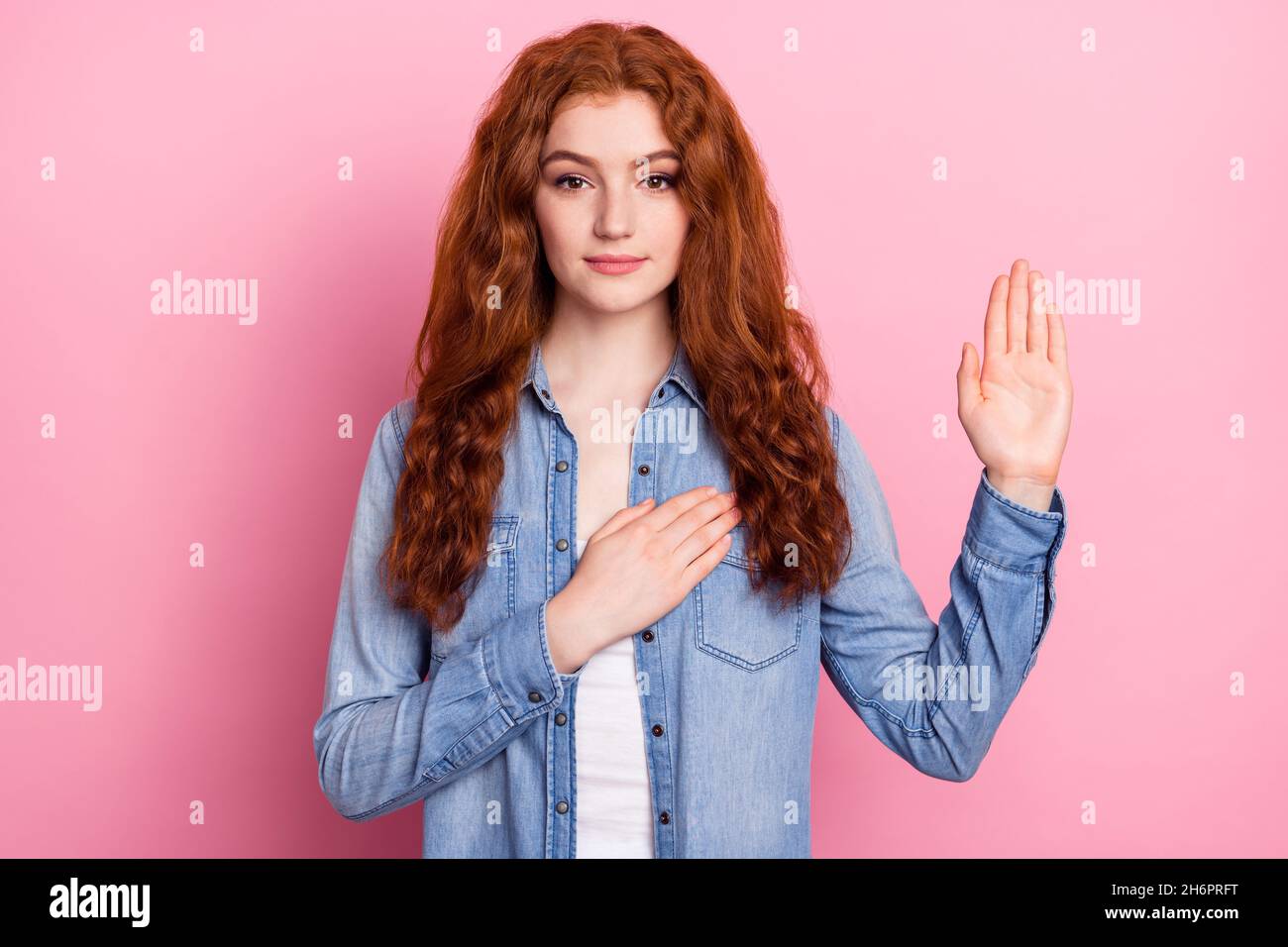 Photo of young girl hand on heart make oath promise tell the truth ...