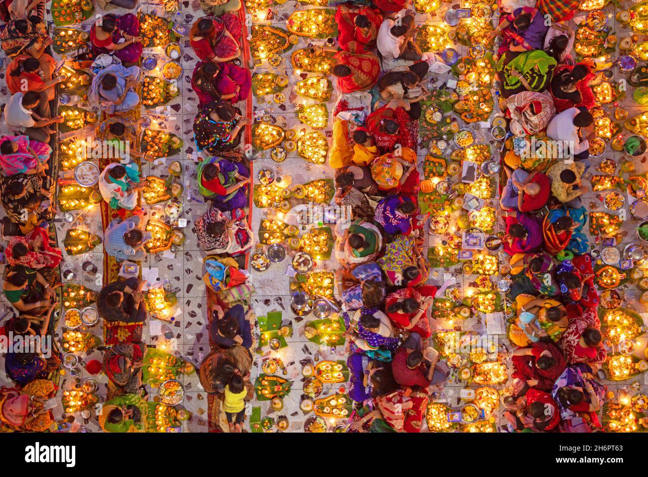 Hindu devotees sit with Prodip (lights) and pray to God for the welfare ...