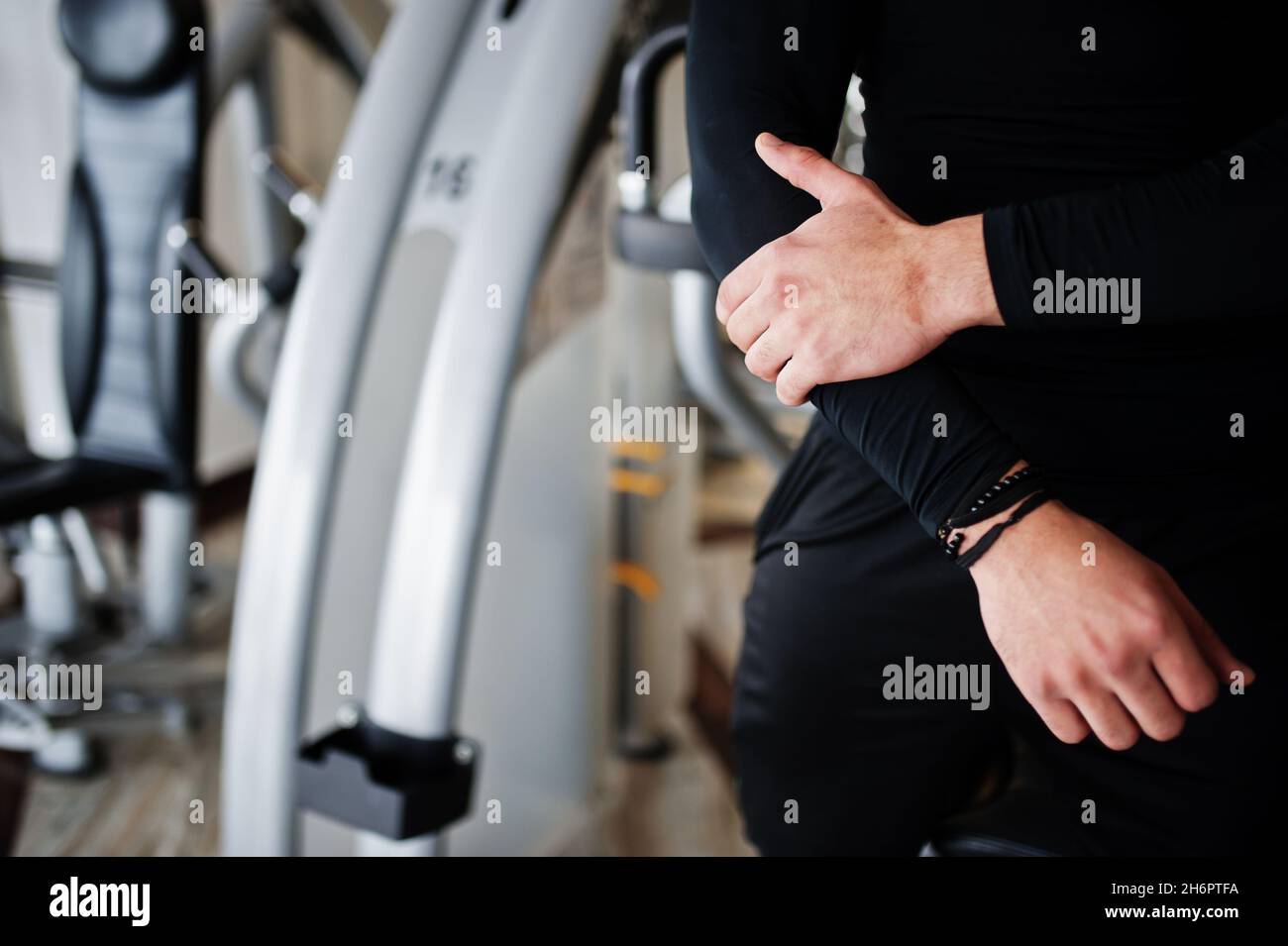 Muscular arab man training and doing workout on fitness machine in ...