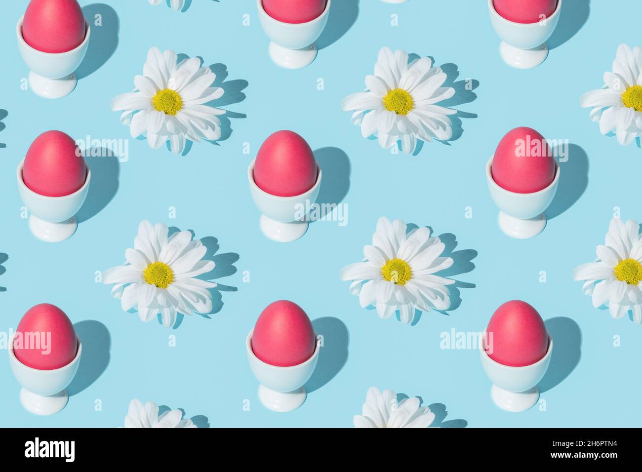 Creative pastel spring background with easter eggs and daisy flowers ...