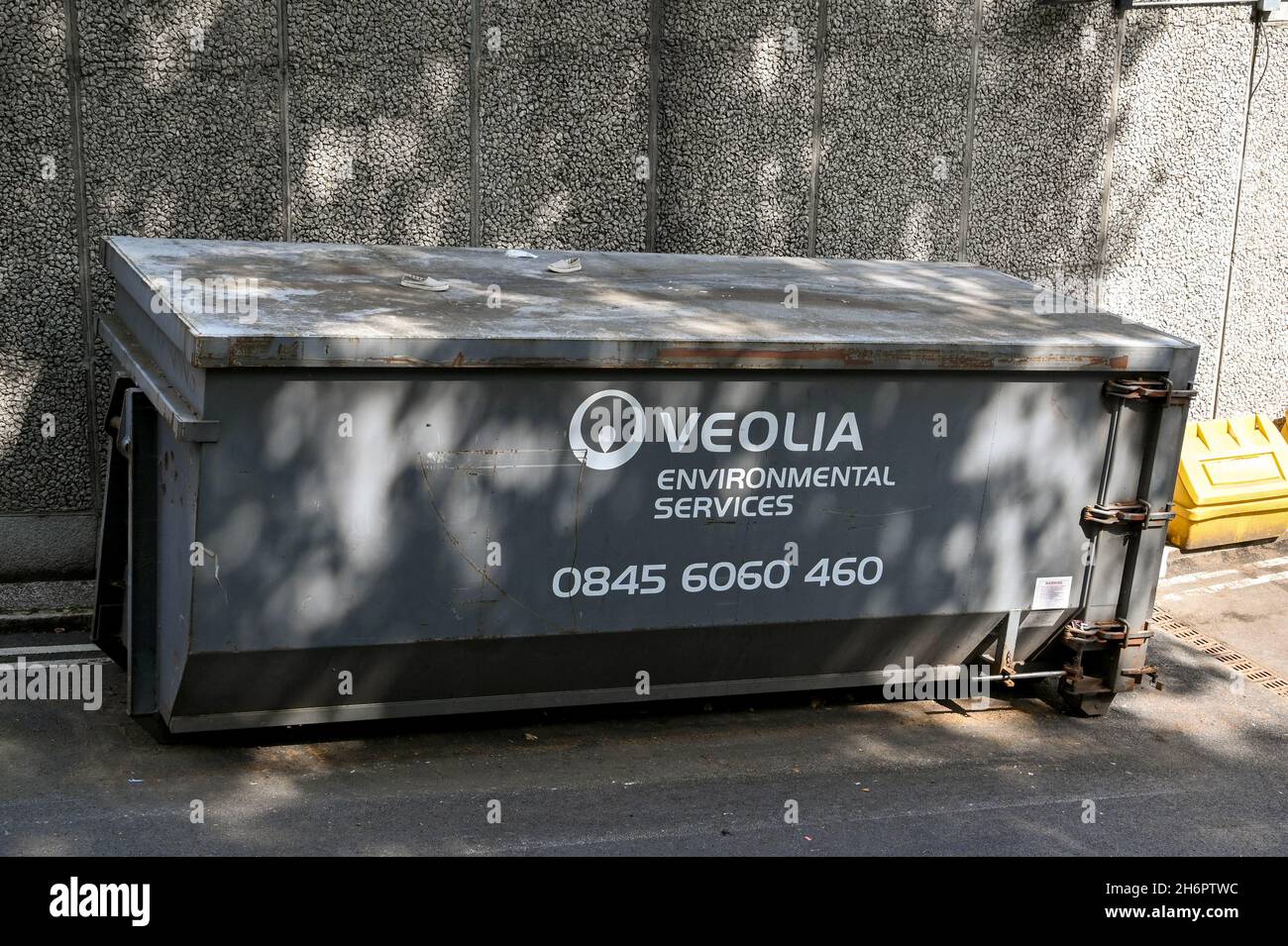 London, England - August 2021: Large industrial rubbish container on an ...