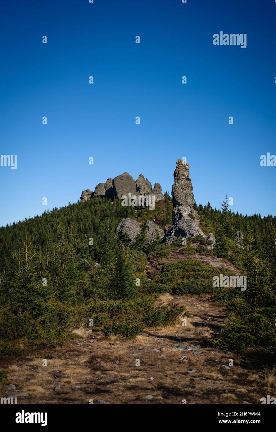 Beautiful scenery of a big rocks on the top of a cliff under a clear ...