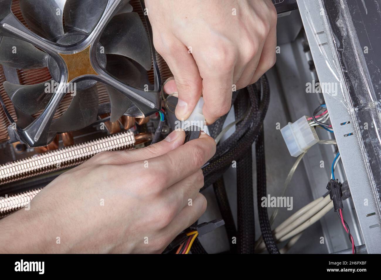 Connecting computer connectors, laying wires, cleaning dust Stock Photo ...