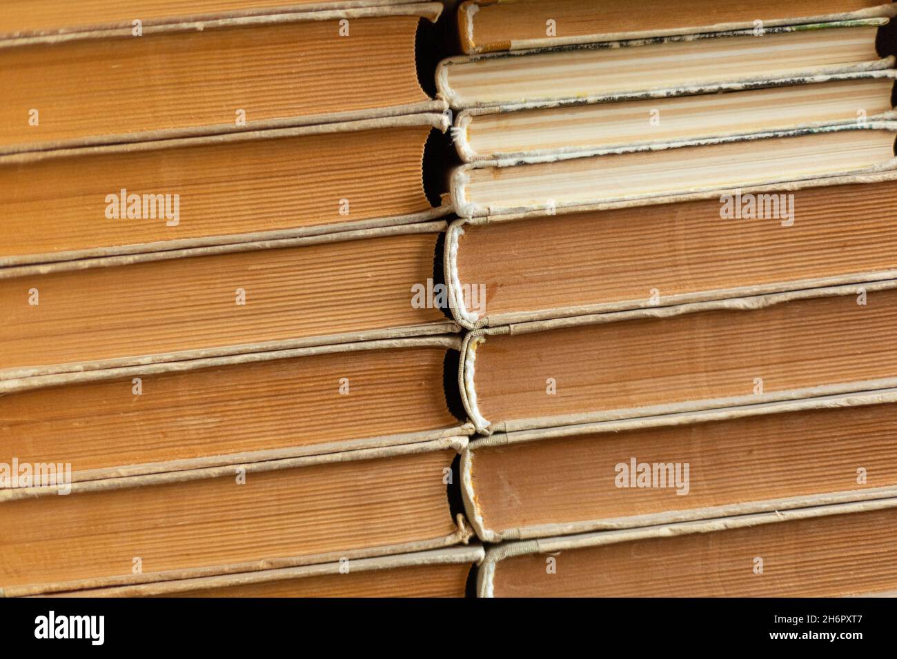 Old vintage yellowed pages of books stand in rough texture side view ...